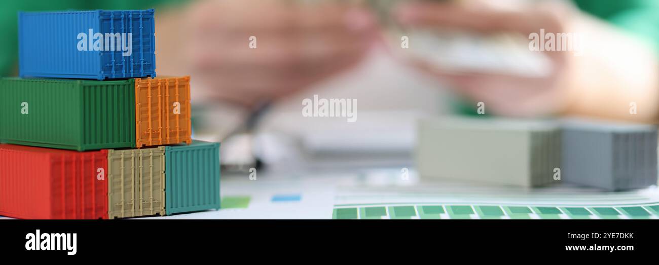 Logistic containers against manager counting money cash Stock Photo - Alamy