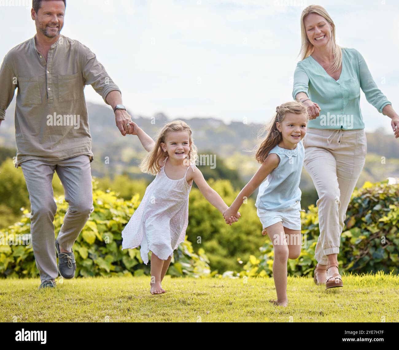 Mother kids holding hands running hi-res stock photography and images ...