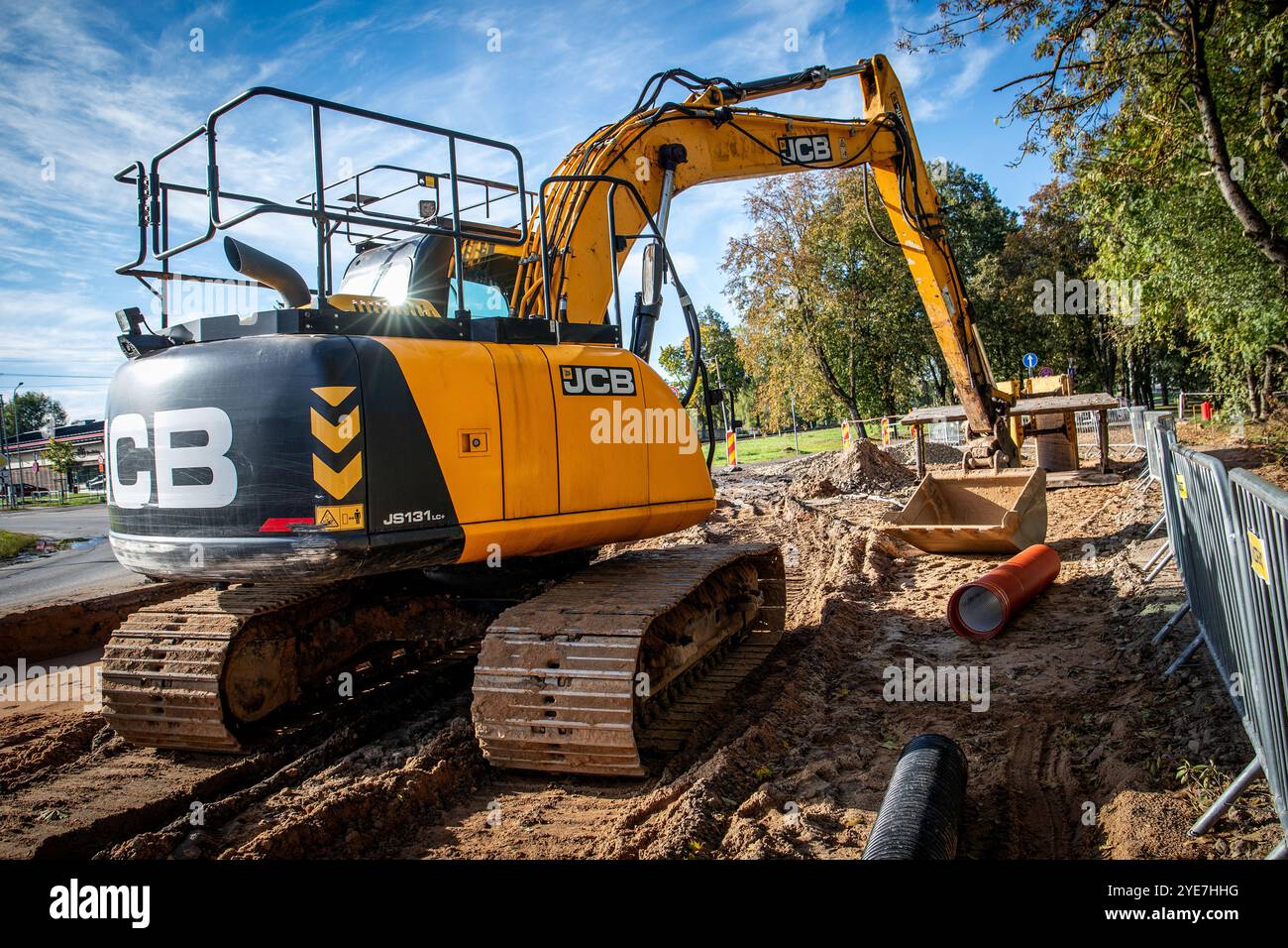 Sigulda, Latvia - October 6, 2024: JCB. An excavator digs the ground ...