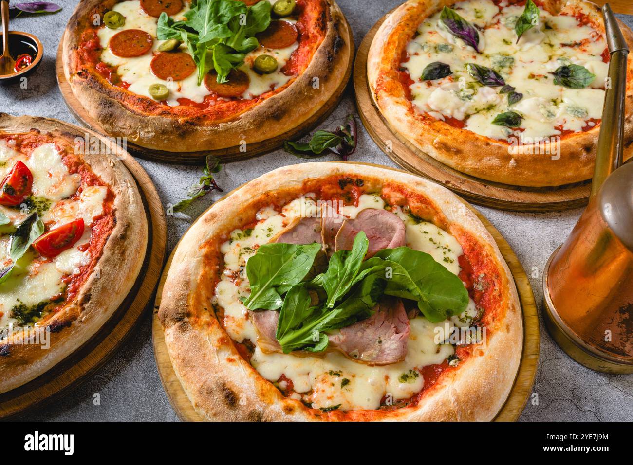 Top view of various neapolitan pizzas on grey stone table Stock Photo ...