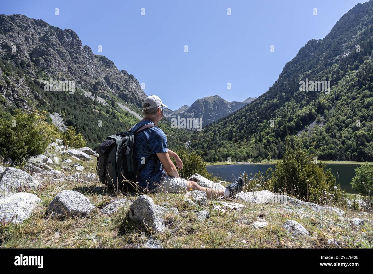 Male backpacker hiking in scenic sunny mountains hi-res stock ...