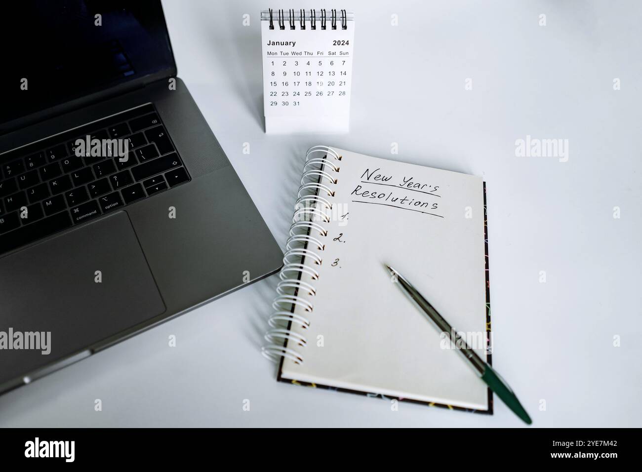 open notepad with resolutions for new 2024 year text. Near laptop ...