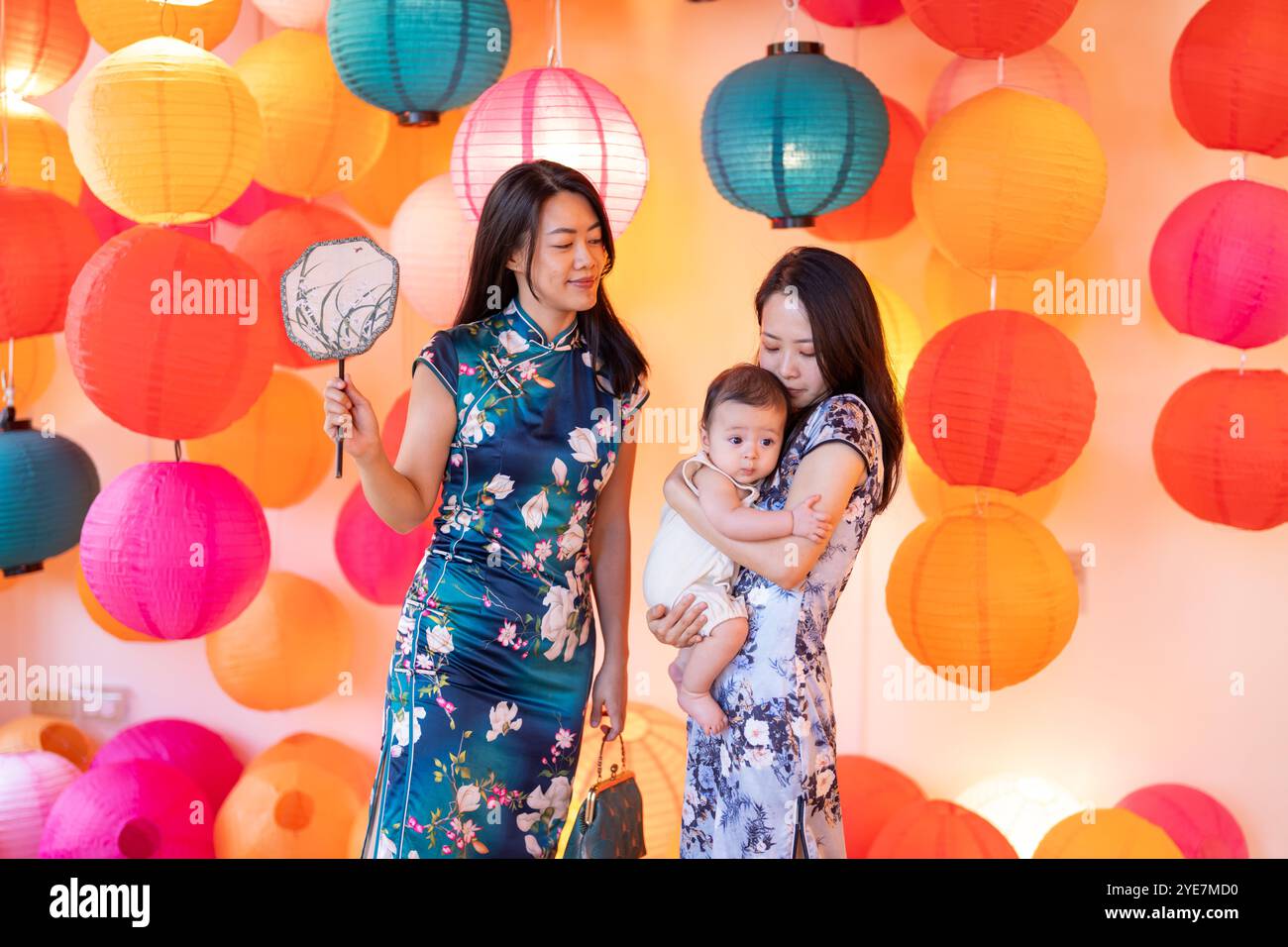 Two women in their 30s wearing traditional Chinese clothing hold a 6 ...
