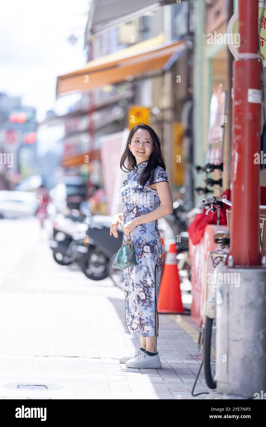 A Taiwanese woman in her 30s wearing traditional Chinese clothing is ...