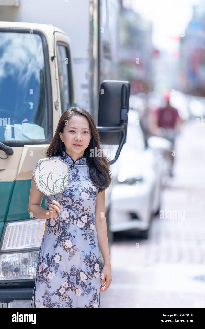 A Taiwanese woman in her 30s wearing traditional Chinese clothing is ...
