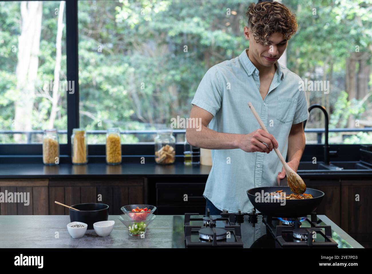 Man cooking in modern kitchen hi-res stock photography and images - Alamy