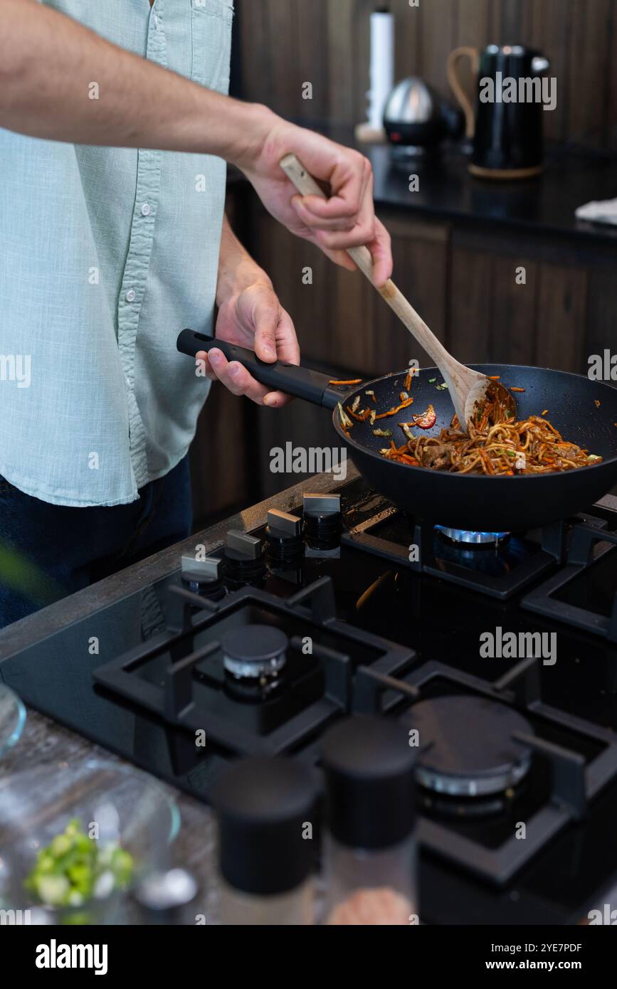 Man cooking on kitchen stove hi-res stock photography and images - Alamy
