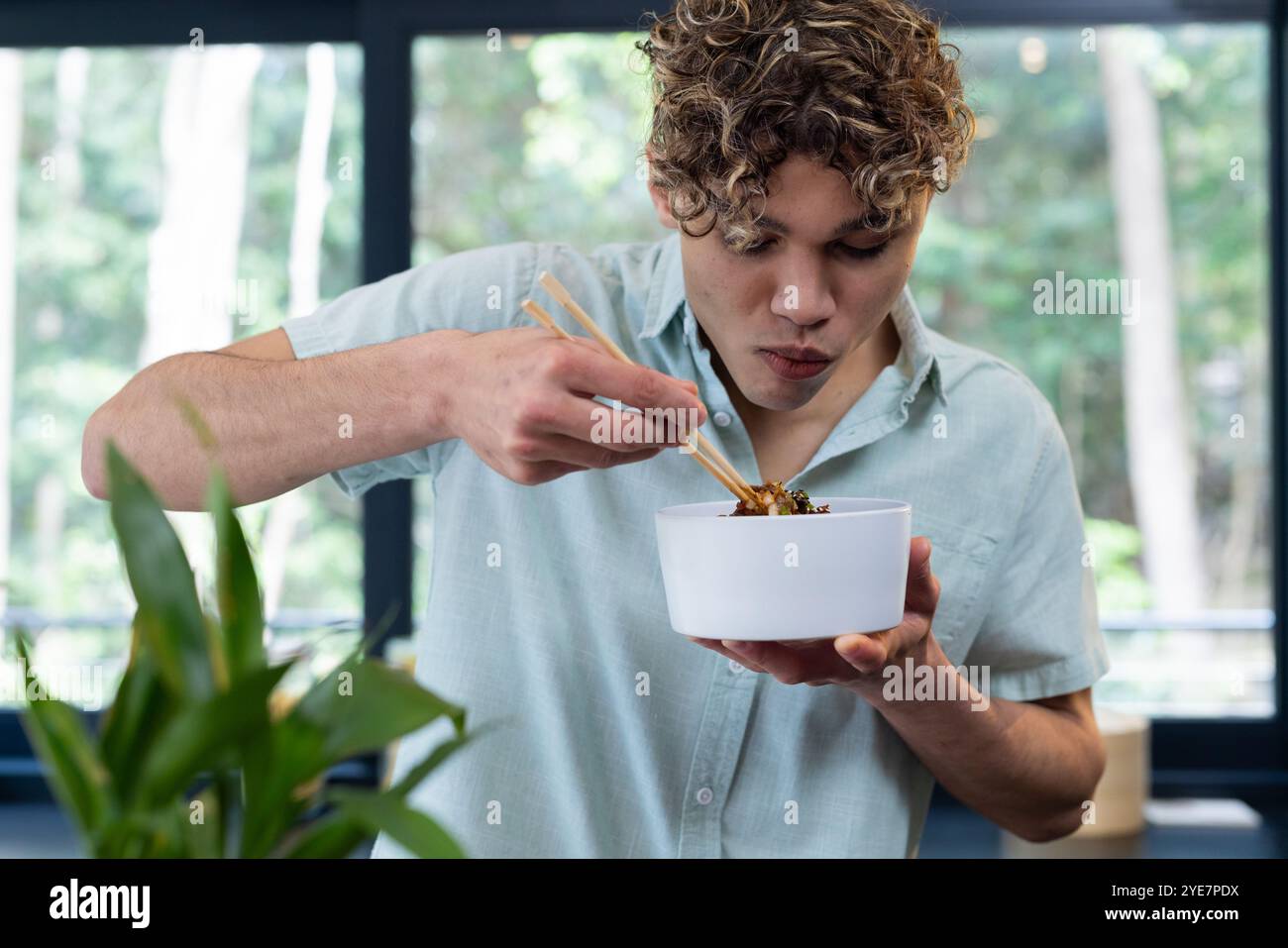 Man eating chopsticks gourmet hi-res stock photography and images - Alamy