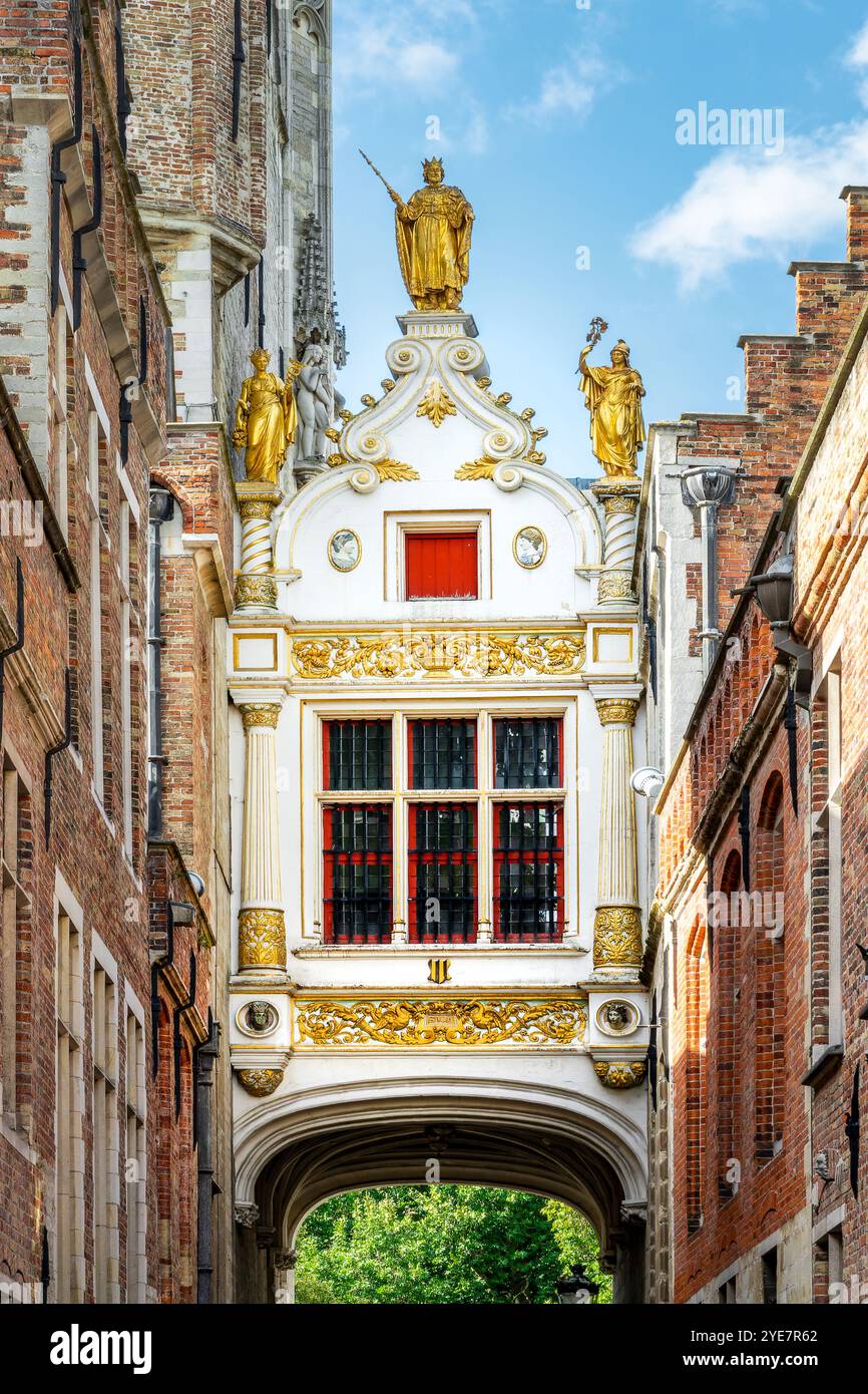 Archway of Brugse Vrije (the Franc of Bruges) with golden statues ...