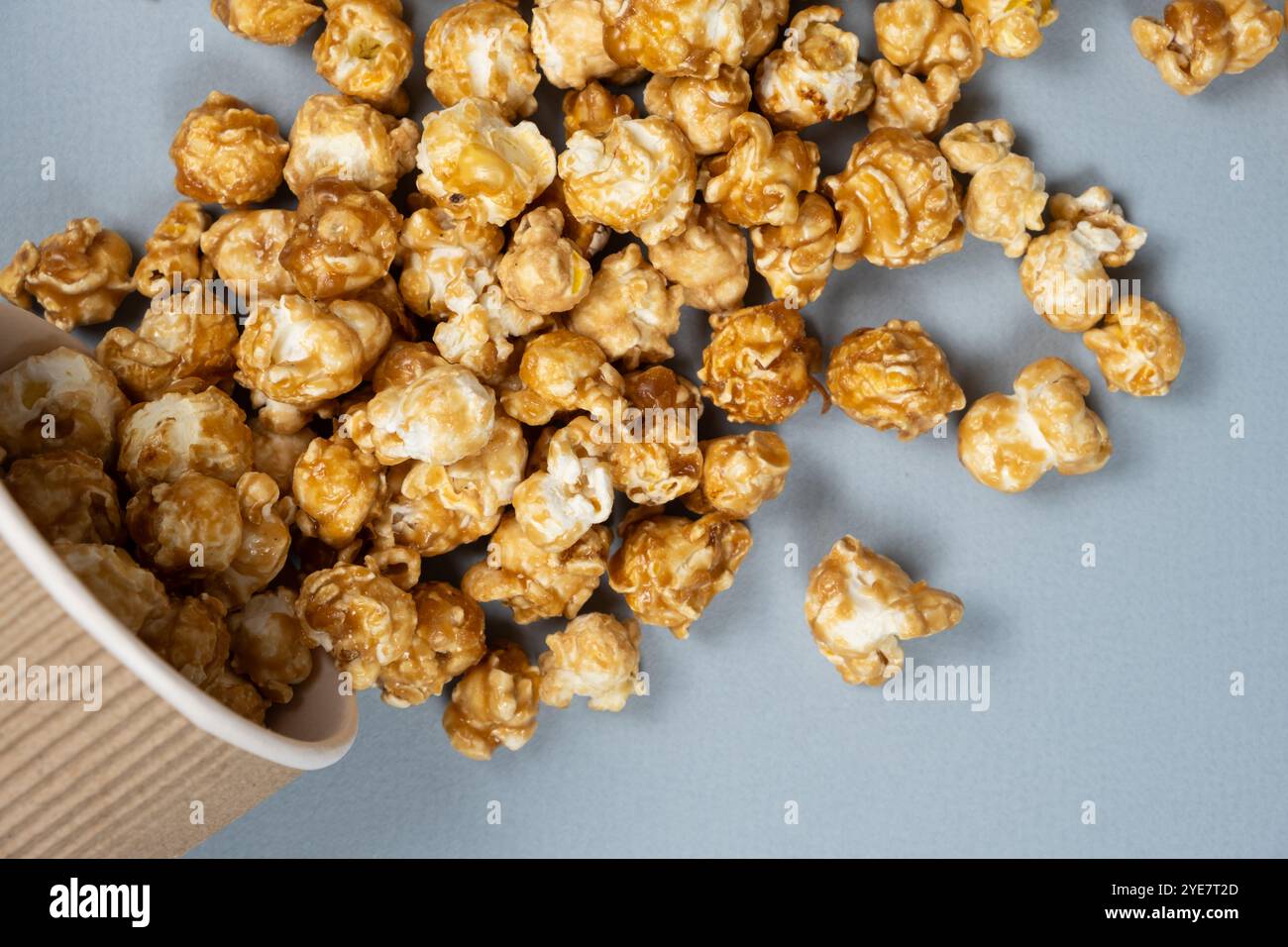 Sweet caramelized popcorn spilled out of the glass Stock Photo - Alamy