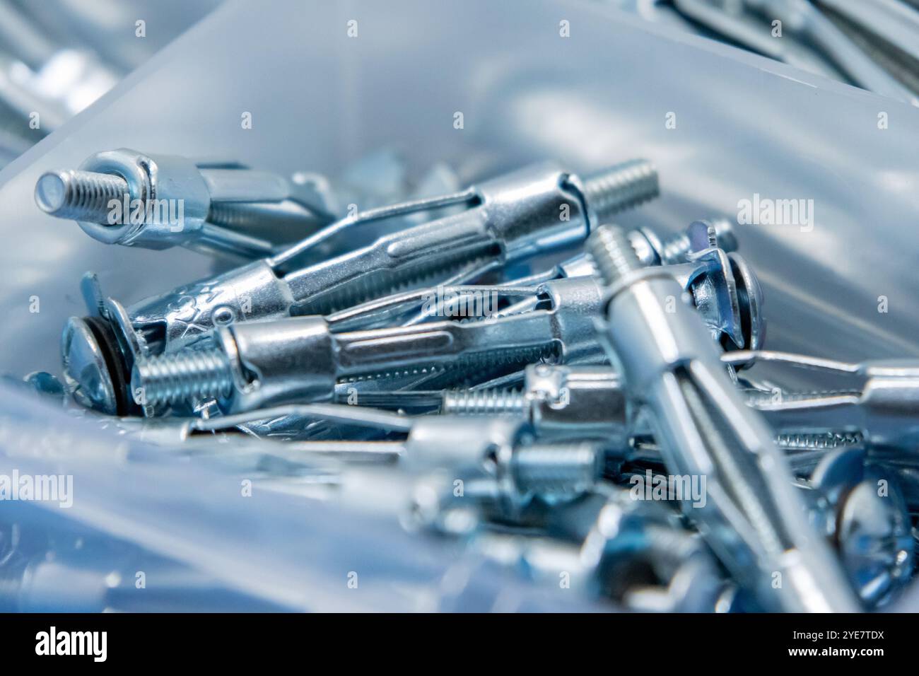 Pile of metal cavity wall anchors are gathered in a plastic organizer ...