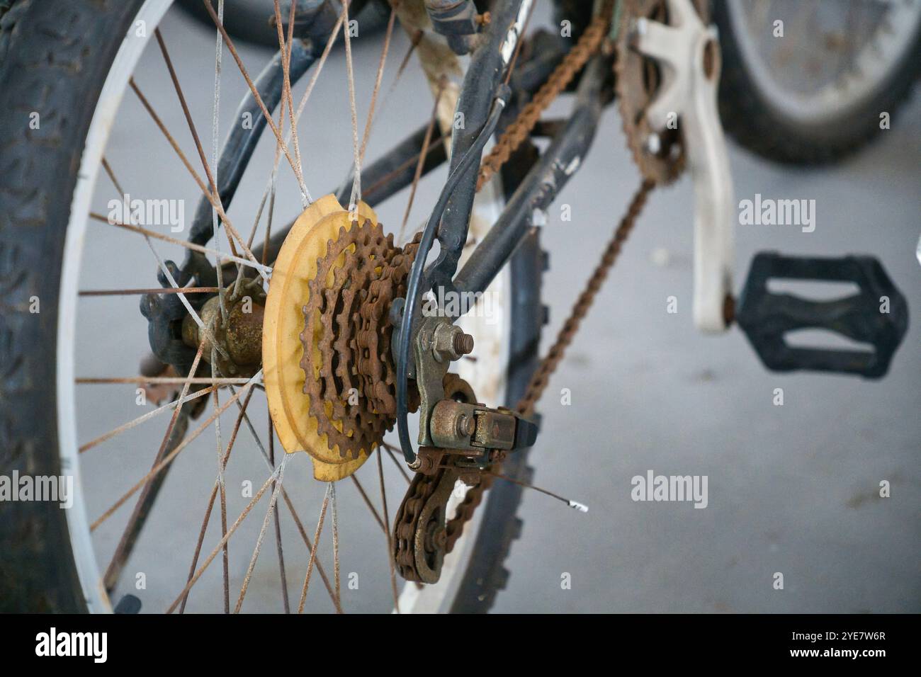 Rusty and old gear cog cassette, chain, and wheel of a bicycle. Dirty ...