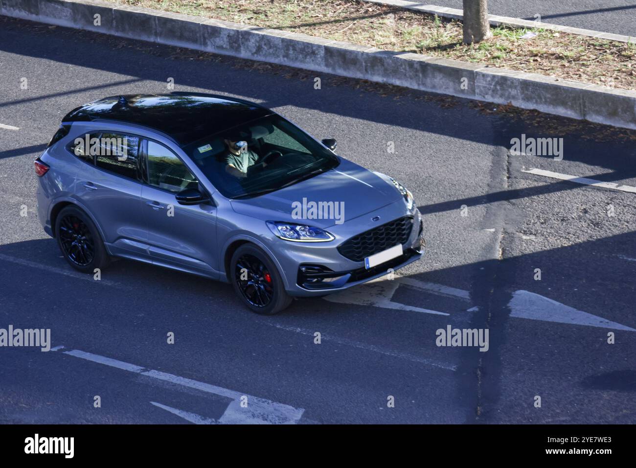 Brand new ford kuga suv is being driven down the road by a man Stock ...