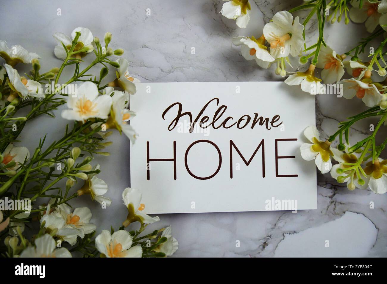 Welcome Home card with flower bouquet decoration top view on marble ...