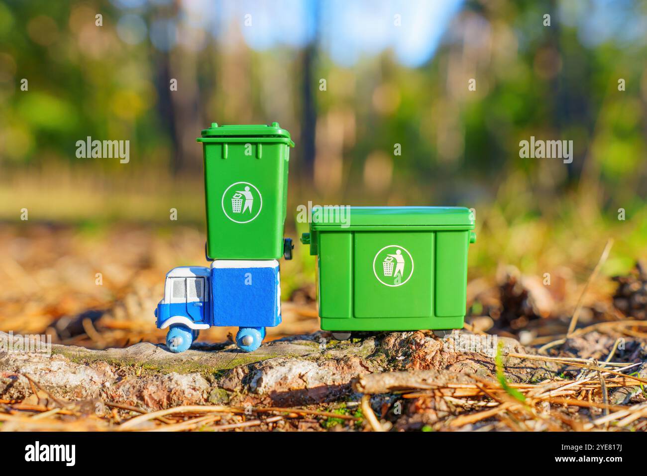 Miniature garbage truck with green recycling bins on forest floor Stock ...