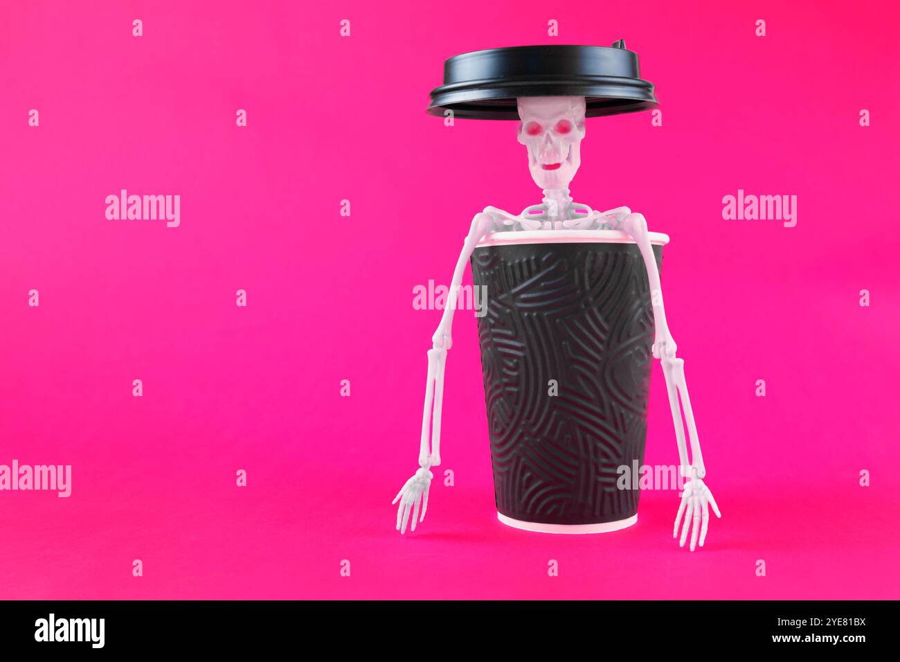 Humorous skeleton figure perched inside a coffee cup against a striking ...