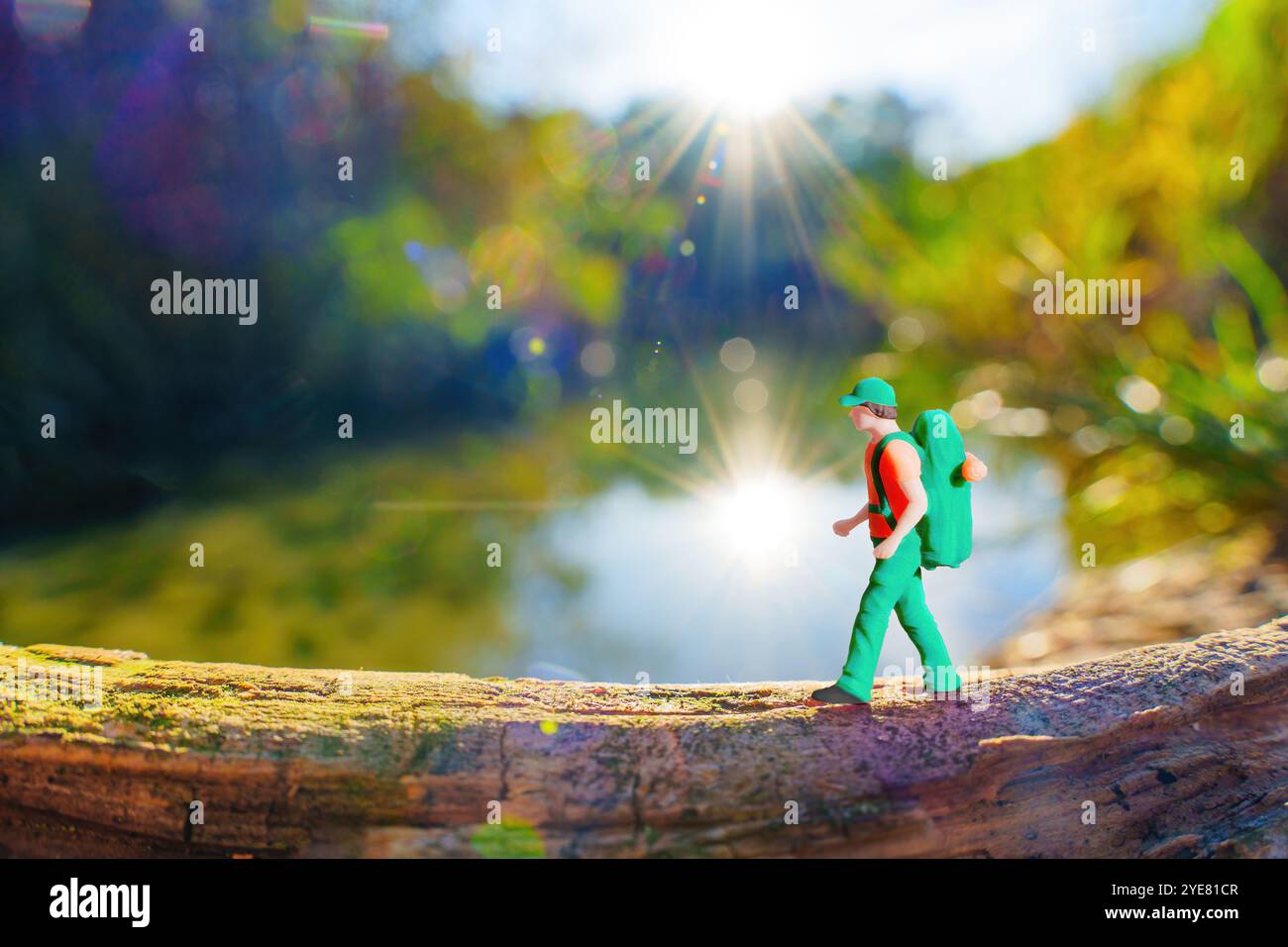 Miniature figurine exploring natural surroundings by a serene lake with ...