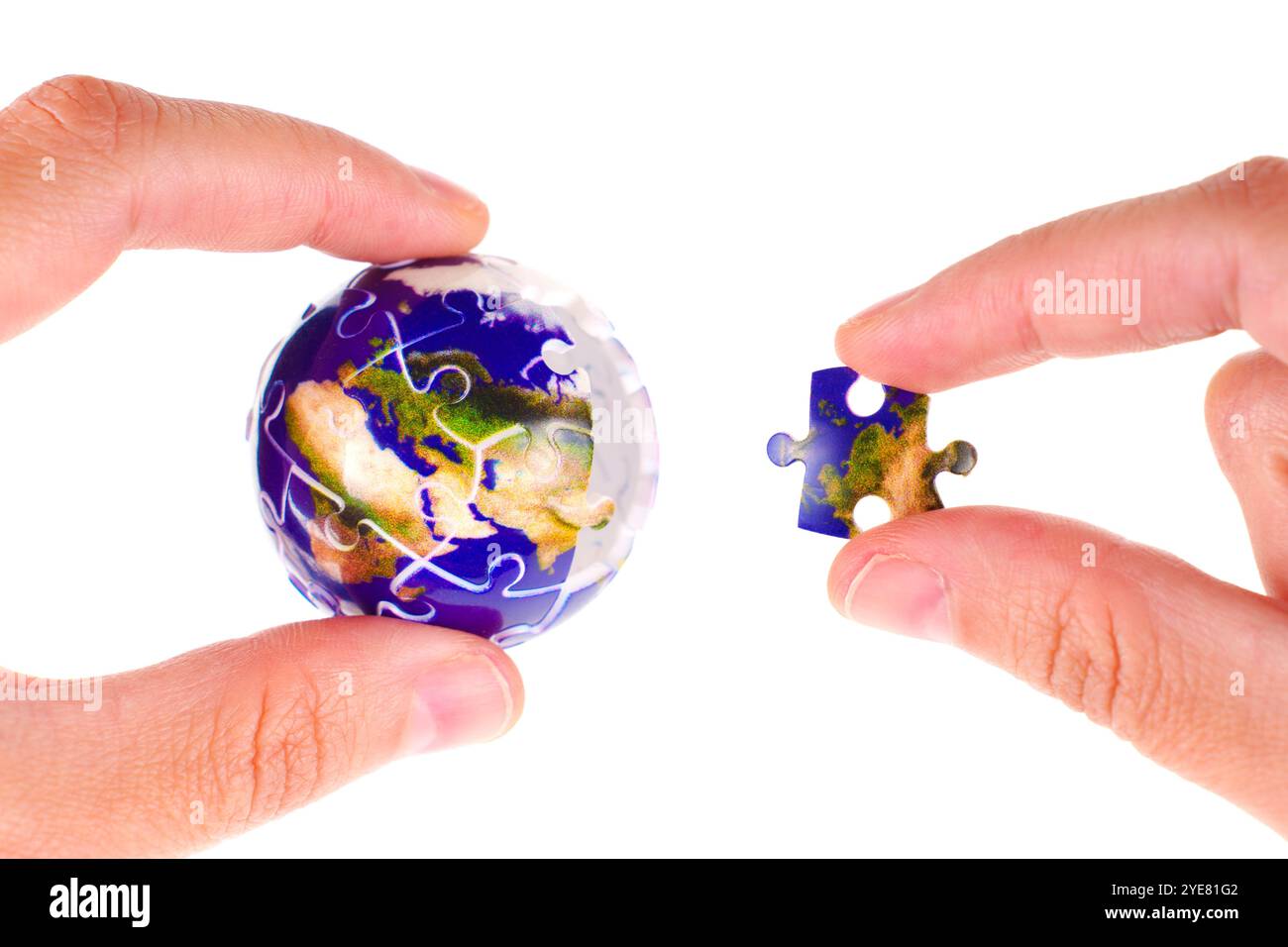 Hands joining a puzzle piece to a colorful globe, representing teamwork and global collaboration ...