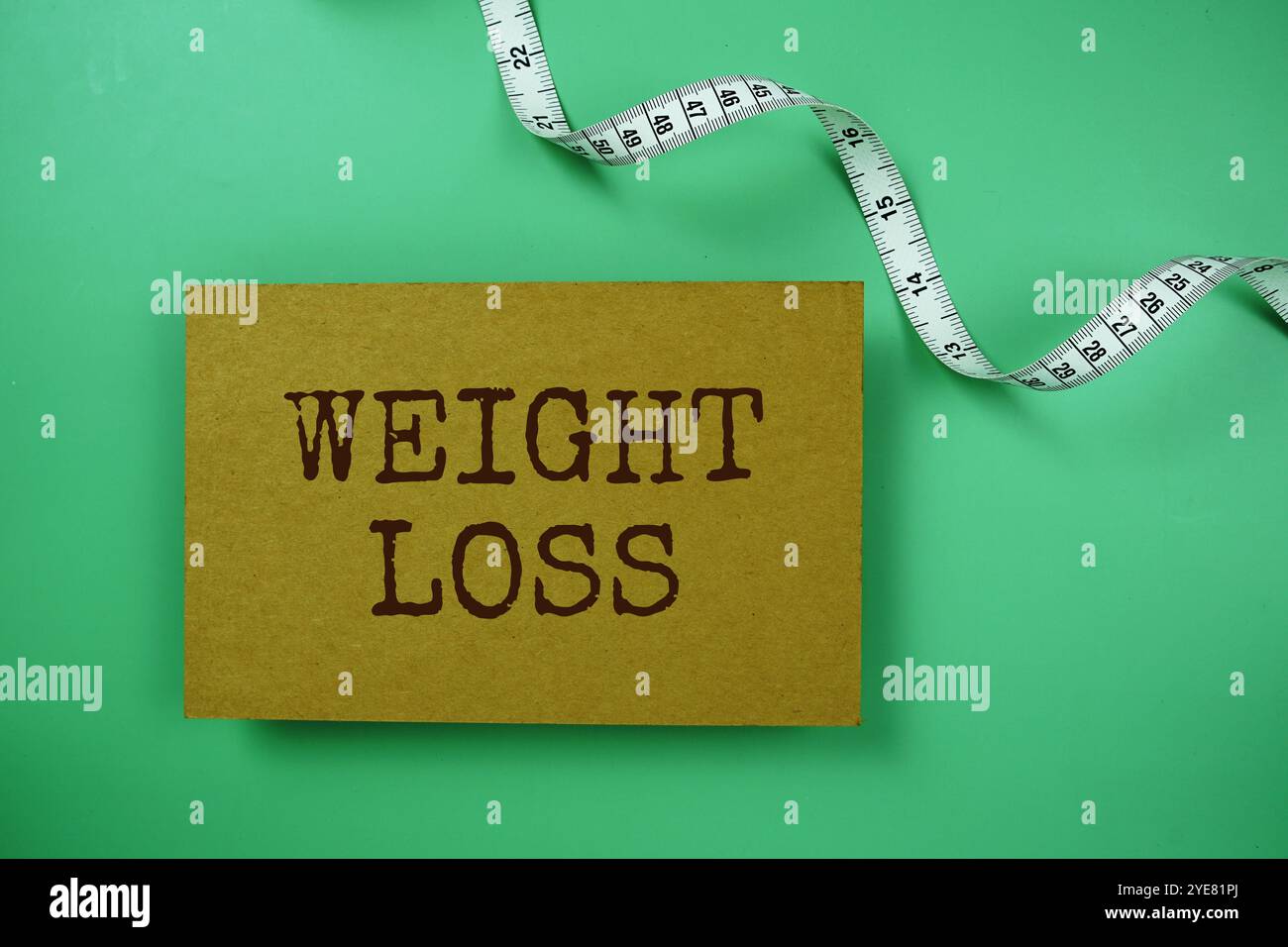 Weight Loss text on paper card with Measuring meter top view on green ...