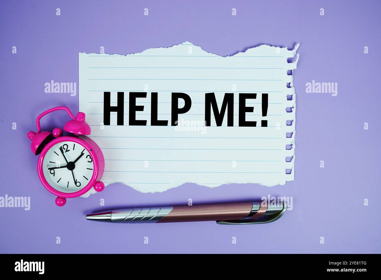 Help Me! text on paper torn with alarm clock top view on purple ...