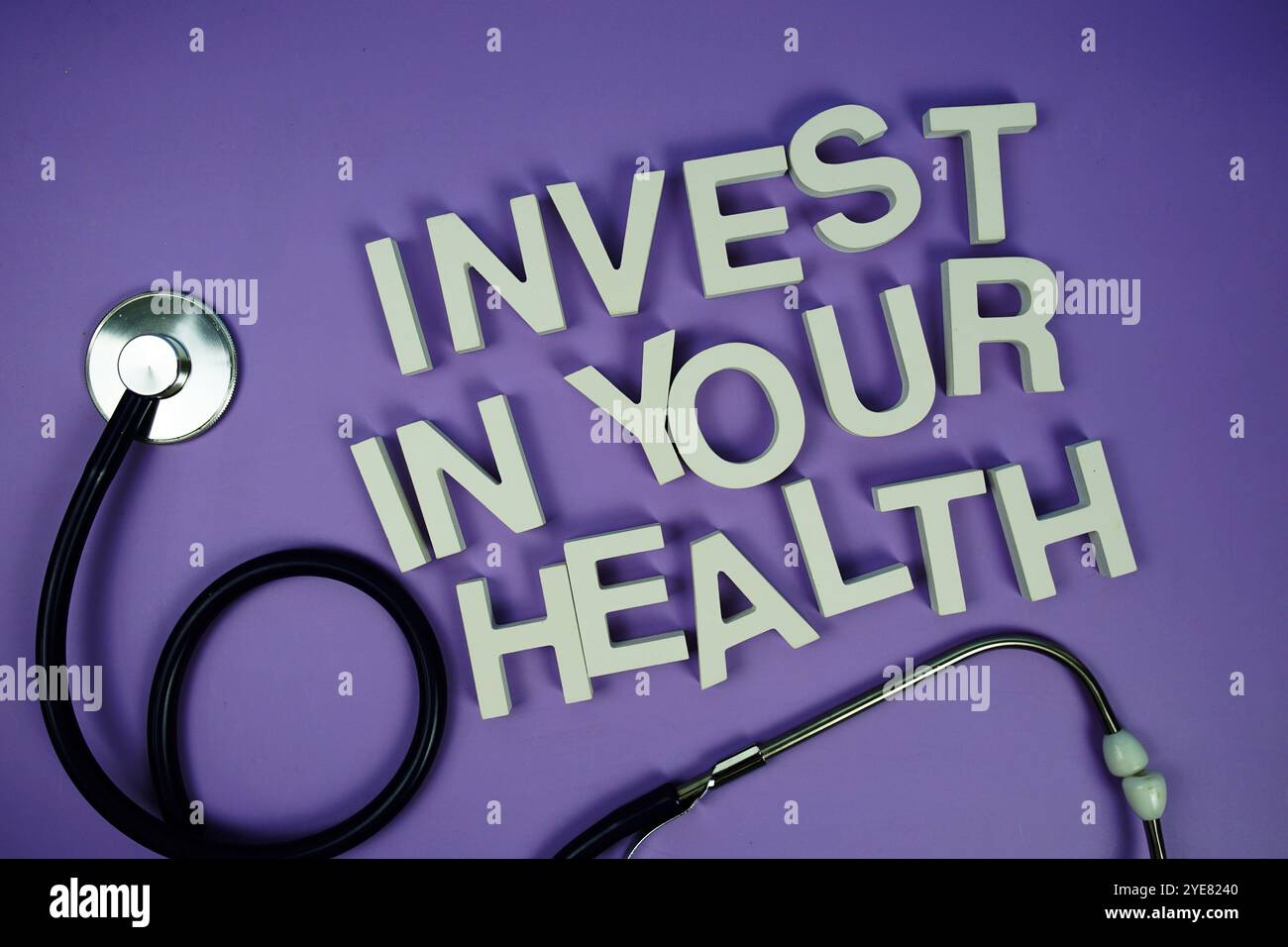 Invest in your health alphabet letters and stethoscope on purple ...