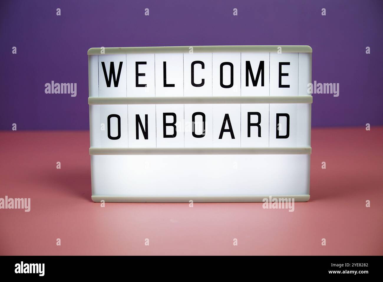 Welcome Onboard letterboard text on LED Lightbox on pink and purple ...