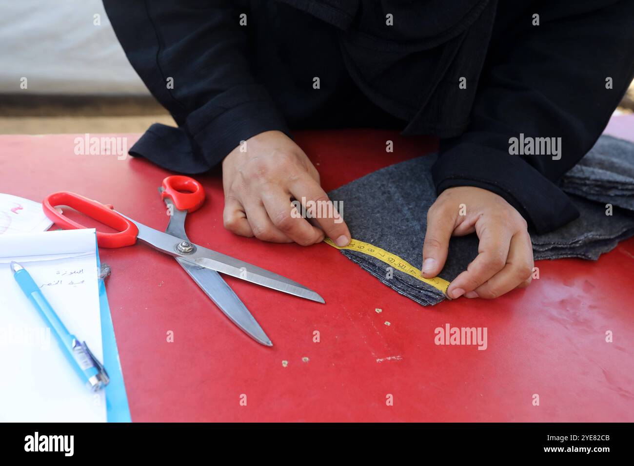 Palestinian Nidaa Attia and another woman work to turn blankets into ...
