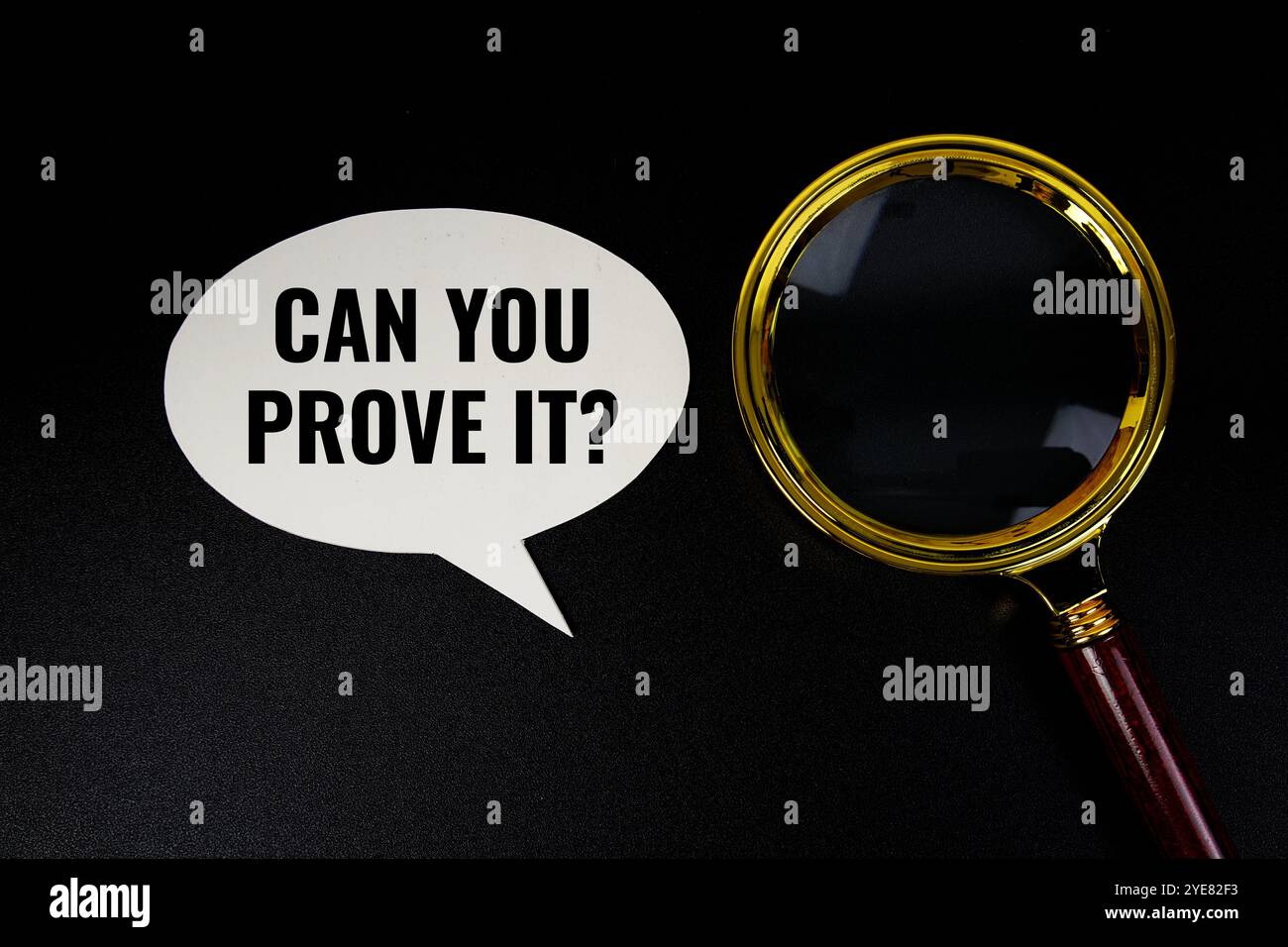 Can you prove it? text on speech bluble with magnifying glass top view ...