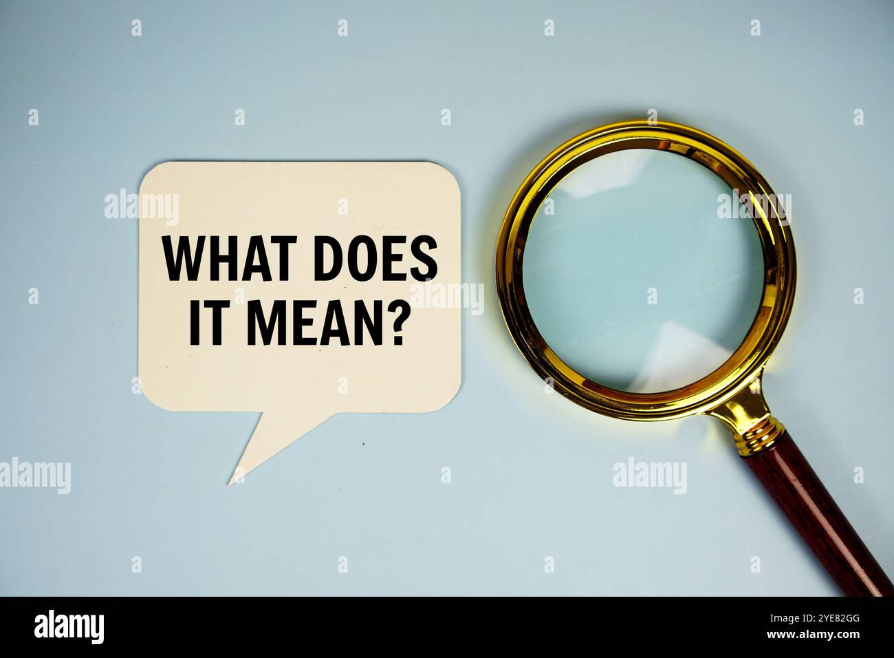 What does it mean? text on speech bluble with magnifying glass top view ...