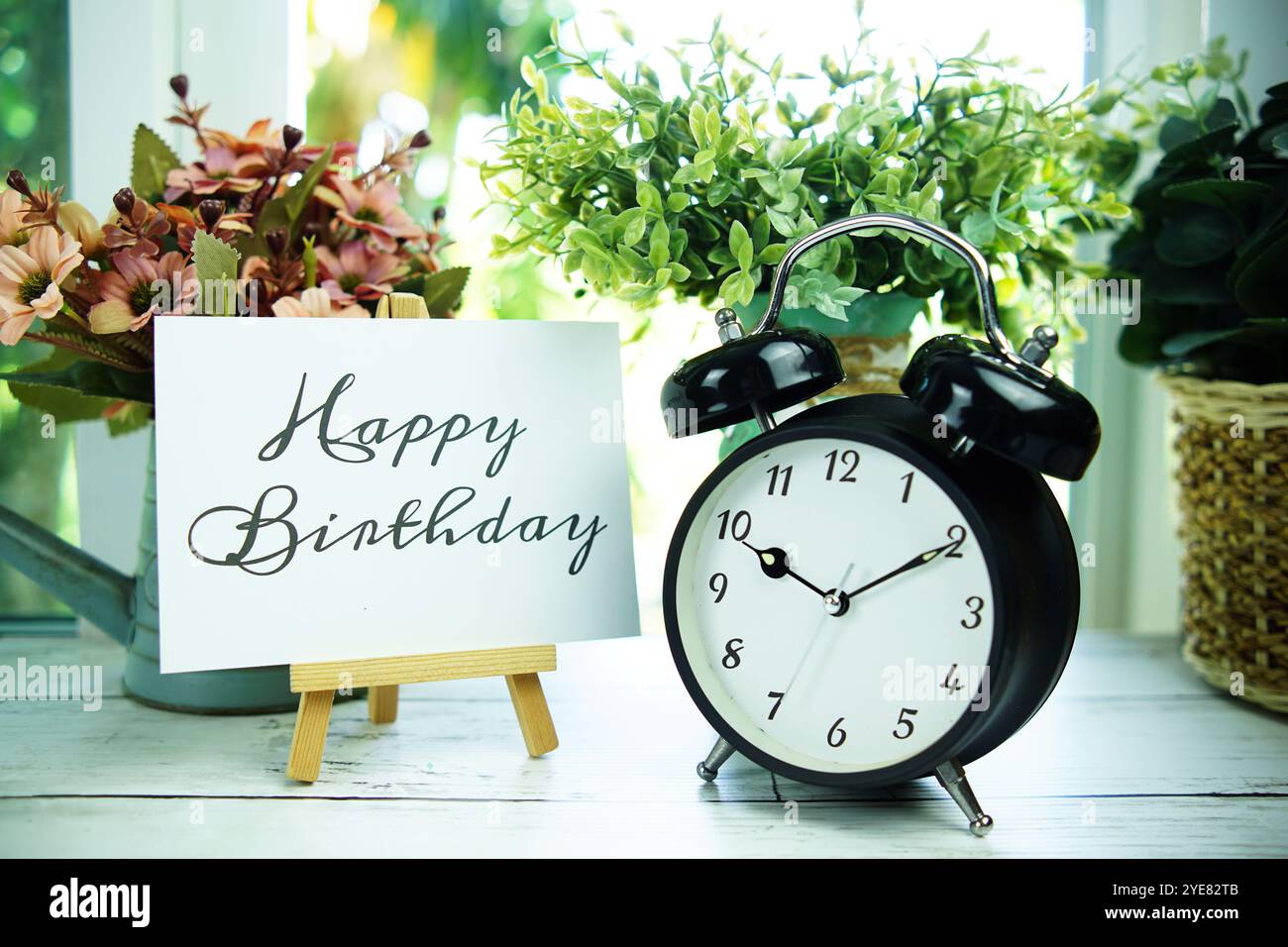 Happy Birthday quotes text on paper card with easel and alarm clock in ...
