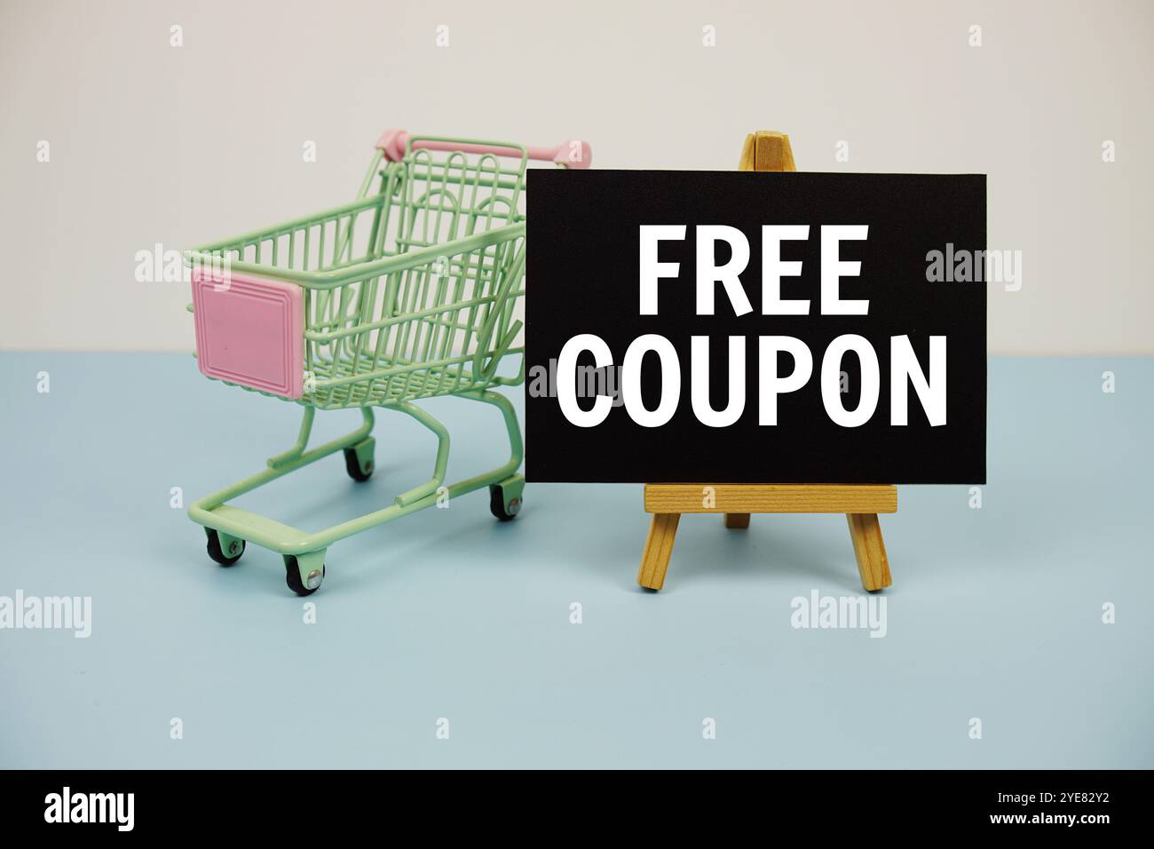 Free Coupon text message and trolley shopping cart on blue background ...