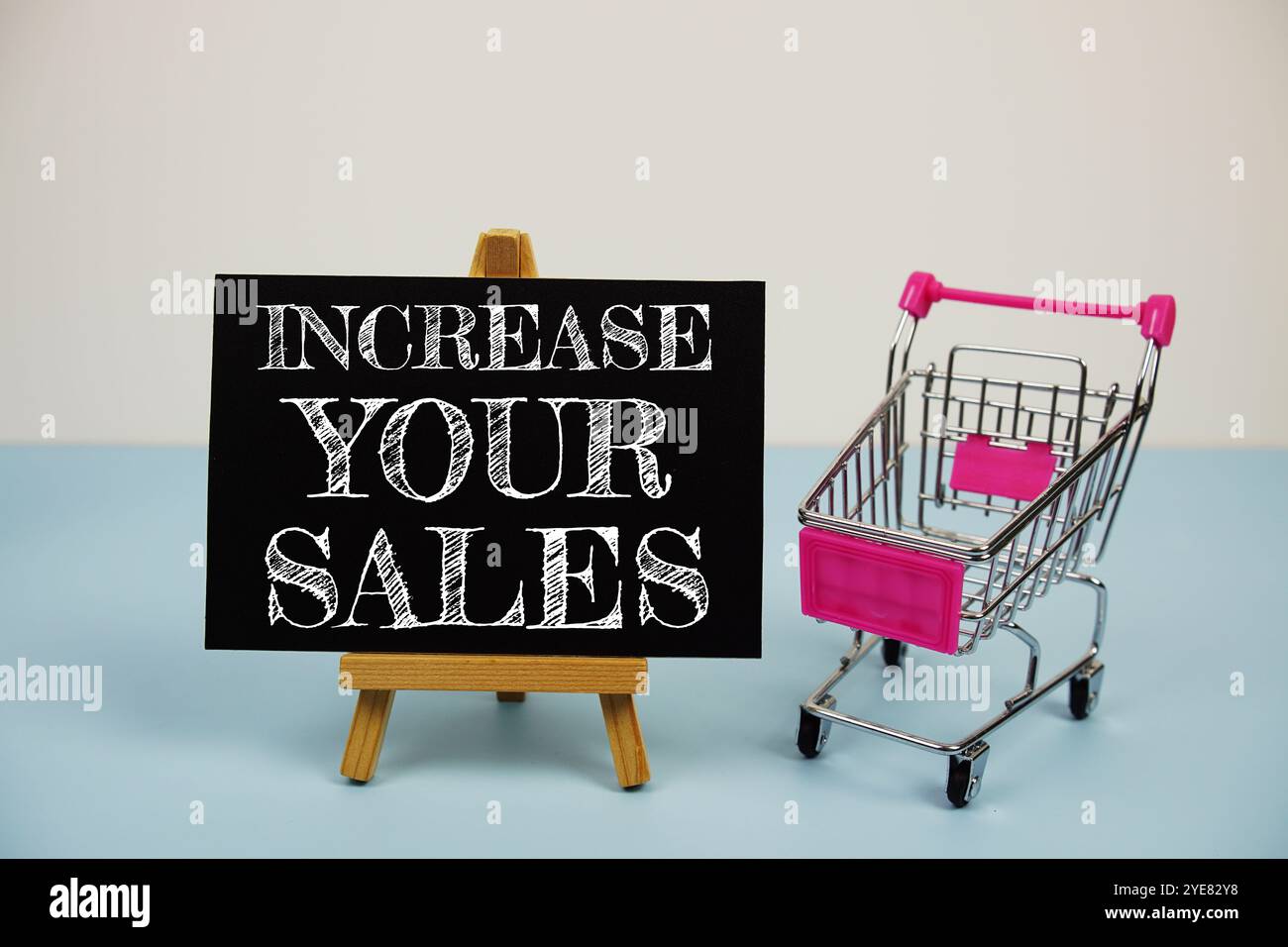 Increase Your Sales text message and trolley shopping cart on blue ...