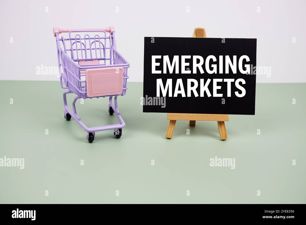Emerging Markets text message and trolley shopping cart on green ...