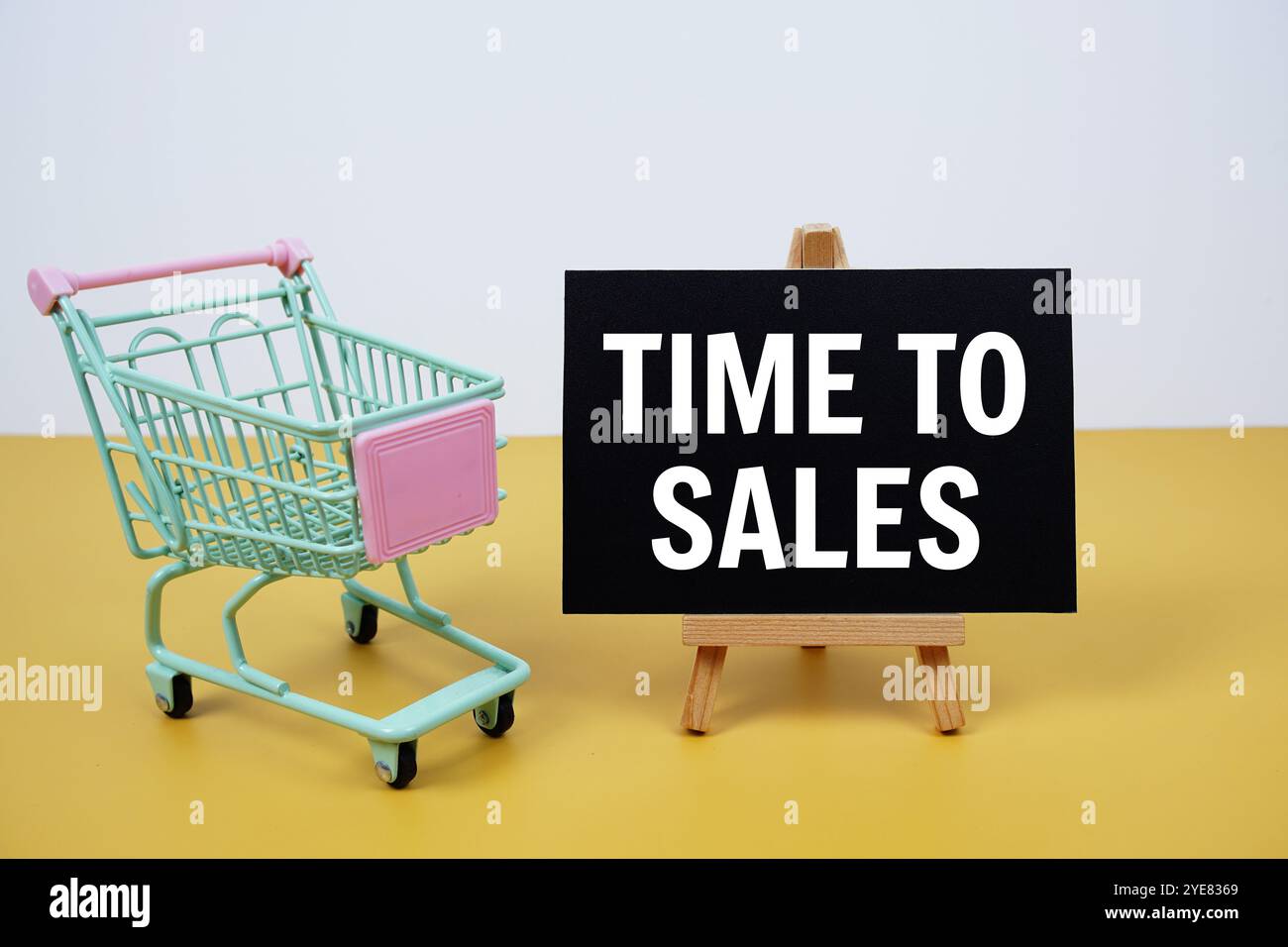 Time To Sales text message and trolley shopping cart on yellow ...