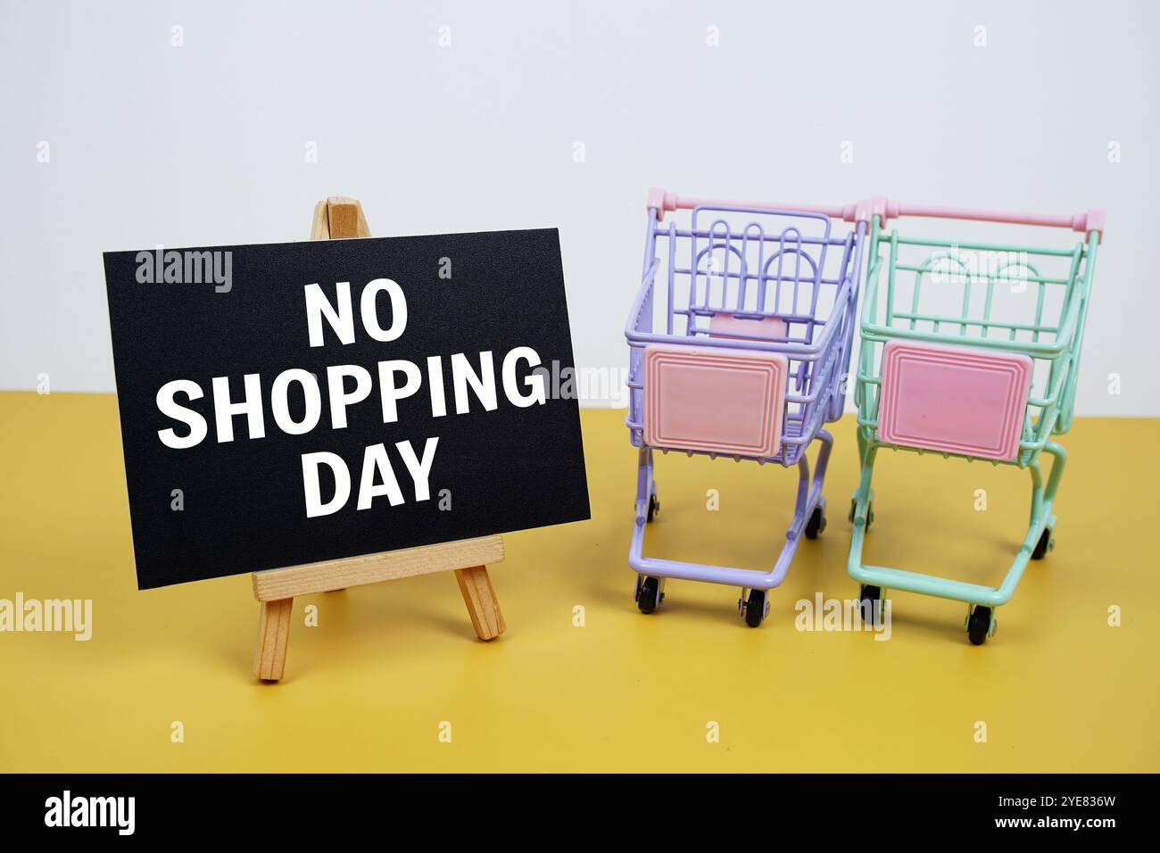No shopping day text message and trolley shopping cart on yellow ...