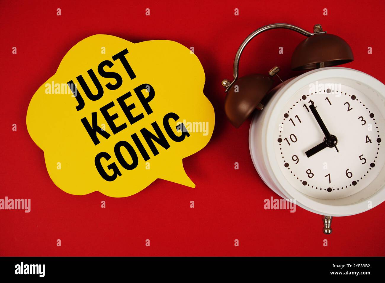 Just Keep Going text on speech bubble with alarm clock on red ...