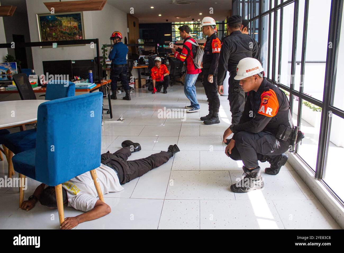 Joint officers attend to a man roleplaying as an injured victim during ...