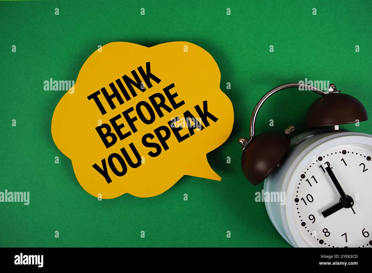 Think Before You Speak text on speech bubble with alarm clock on green ...