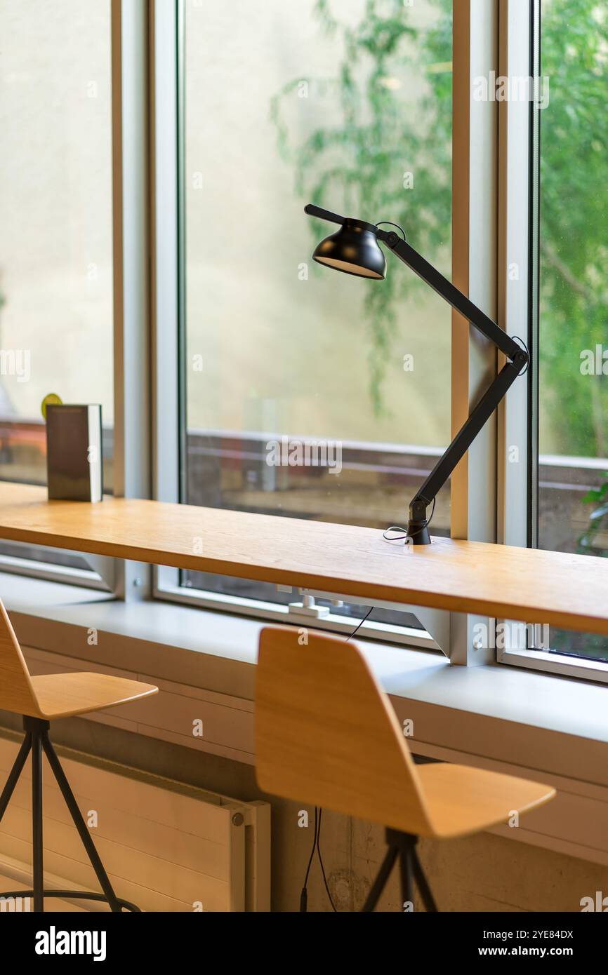 Place to read a book near the window in the city library Stock Photo ...
