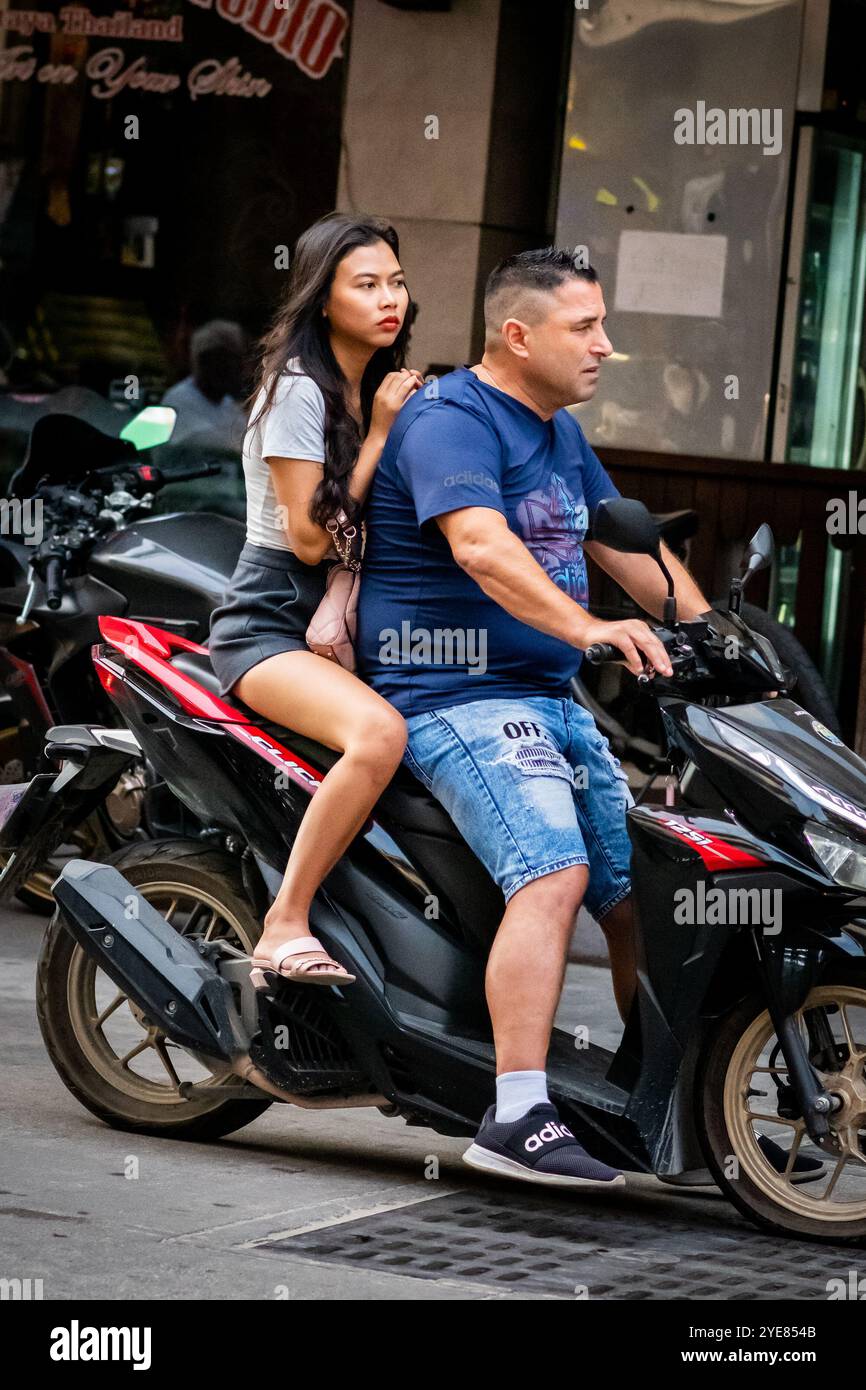 A western man makes his way along Soi Buakhao, Pattaya Thailand with a young thai lady on the ...