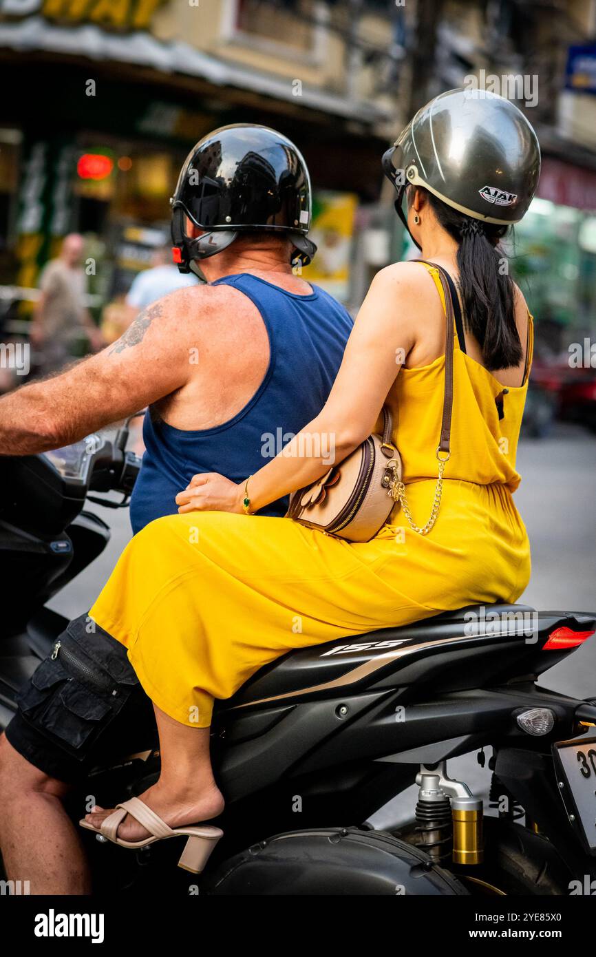 A western man makes his way along Soi Buakhao, Pattaya Thailand with a young thai lady on the ...