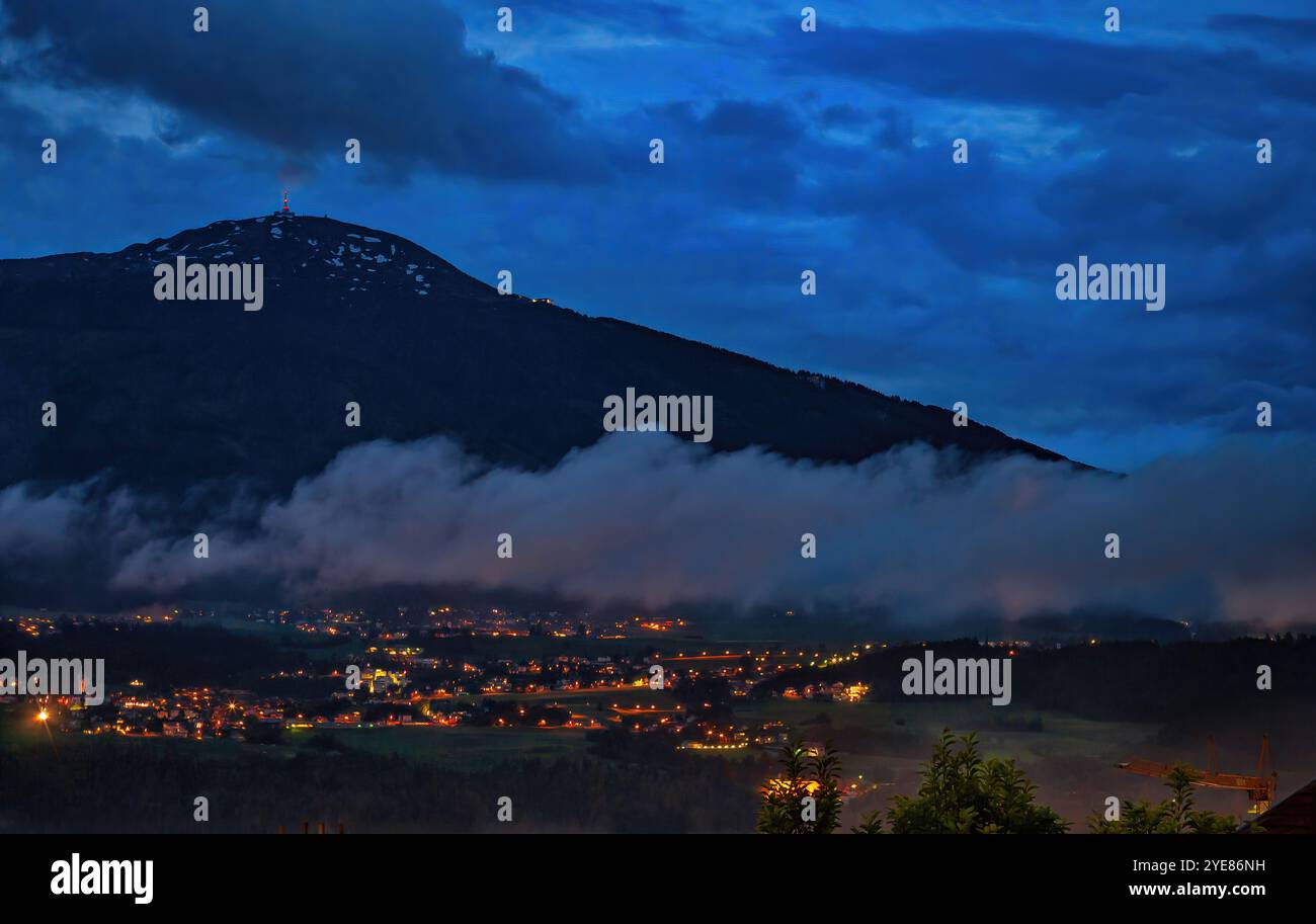 Night view of Patscherkofel mountain and valley with town street lights ...