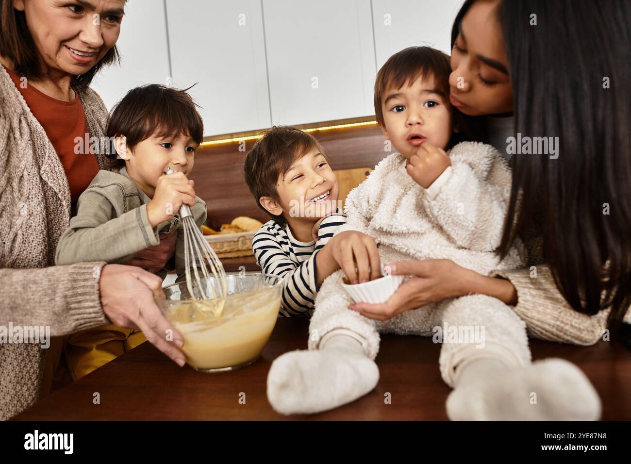 A cheerful family enjoys a holiday baking session in their modern ...