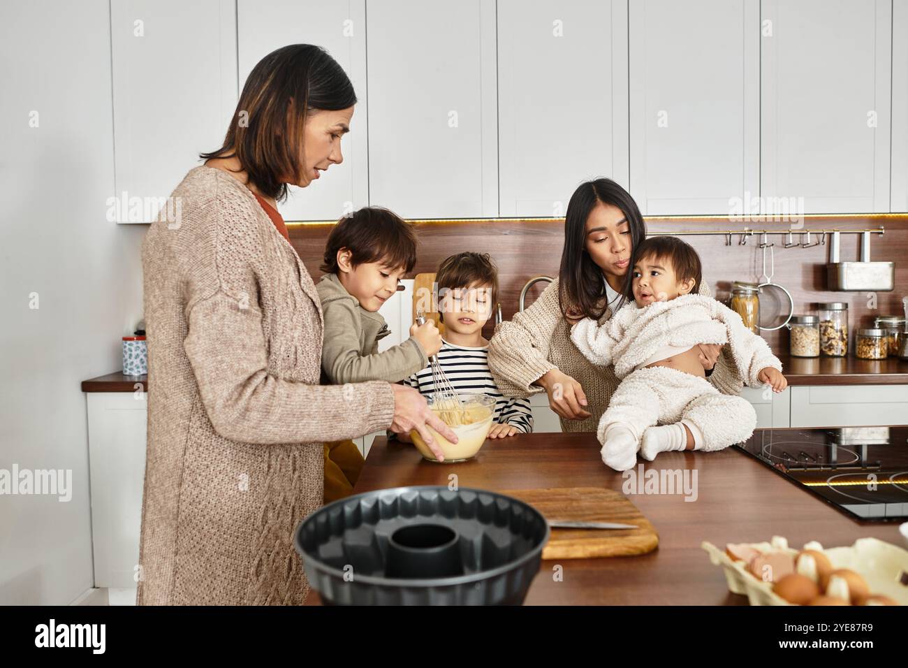 A cheerful family gathers in a modern kitchen, enjoying baking ...