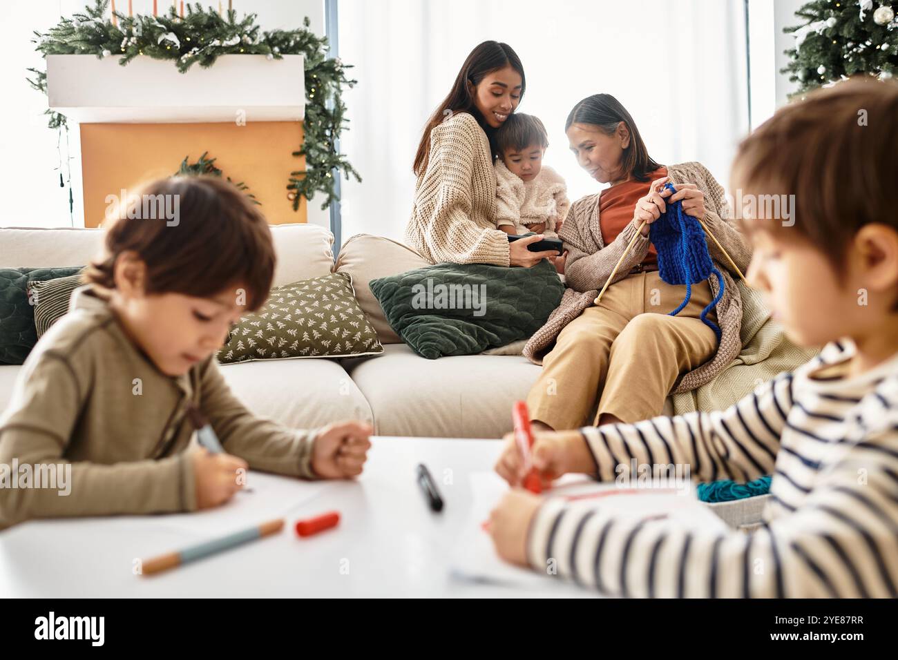 A cheerful family enjoys the holiday season by the Christmas tree ...
