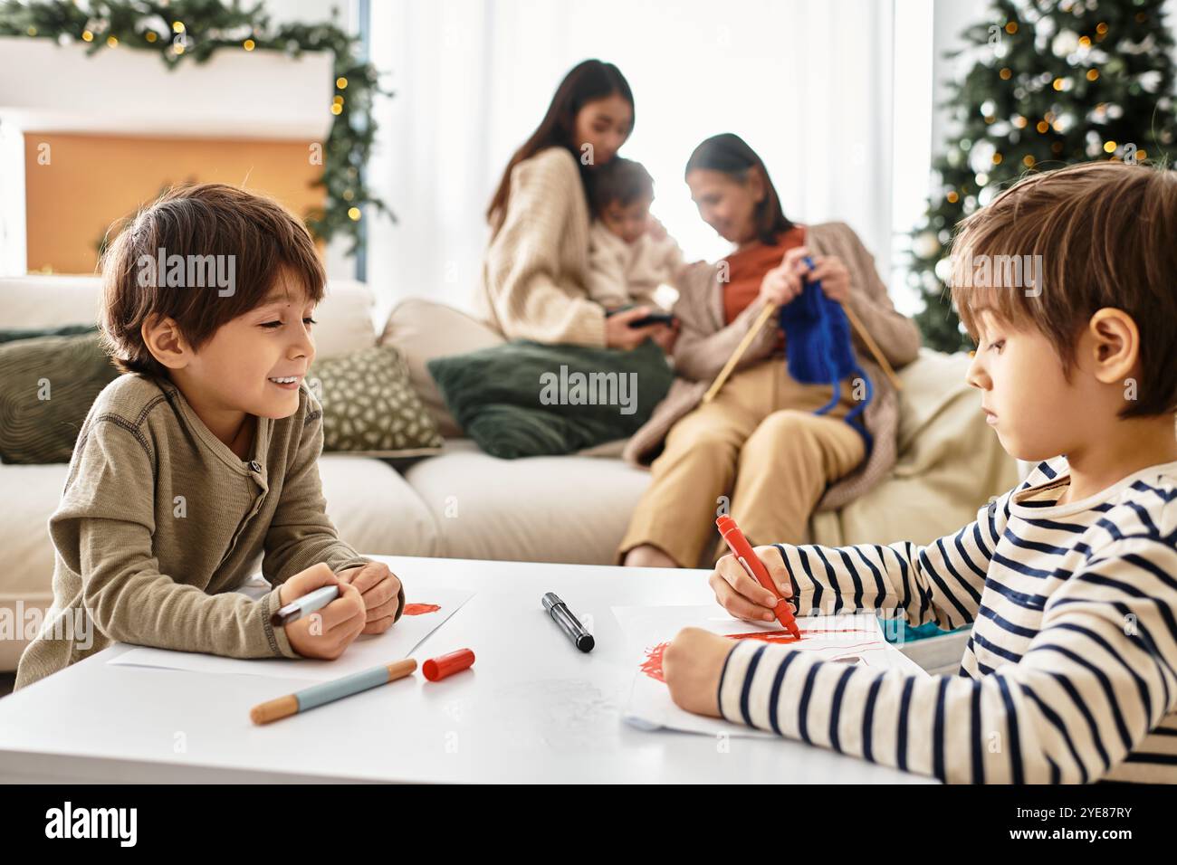 A cheerful family enjoys quality time near the Christmas tree, sharing ...