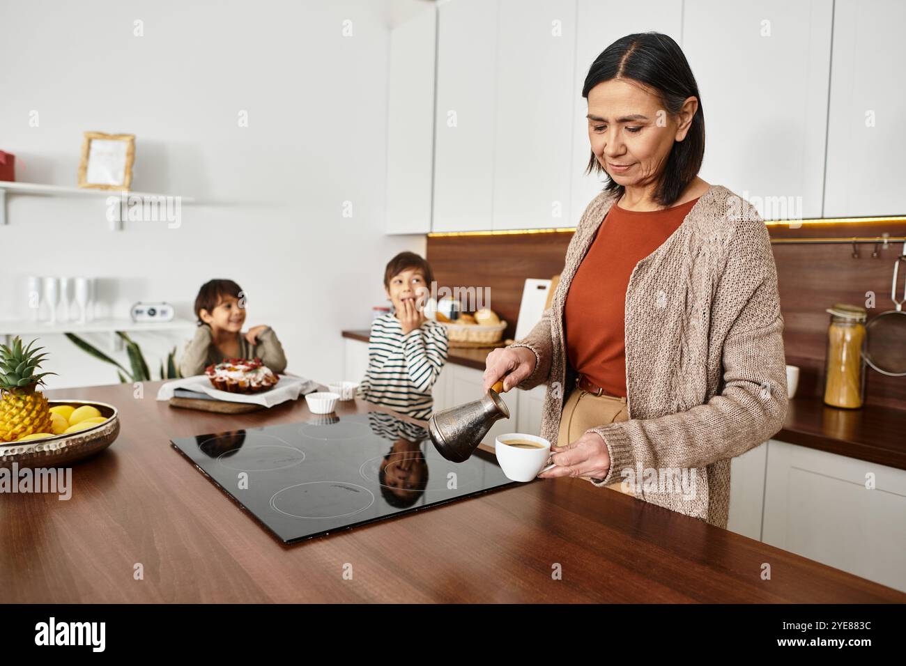 A happy Asian family enjoys baking and cooking together in their cozy ...