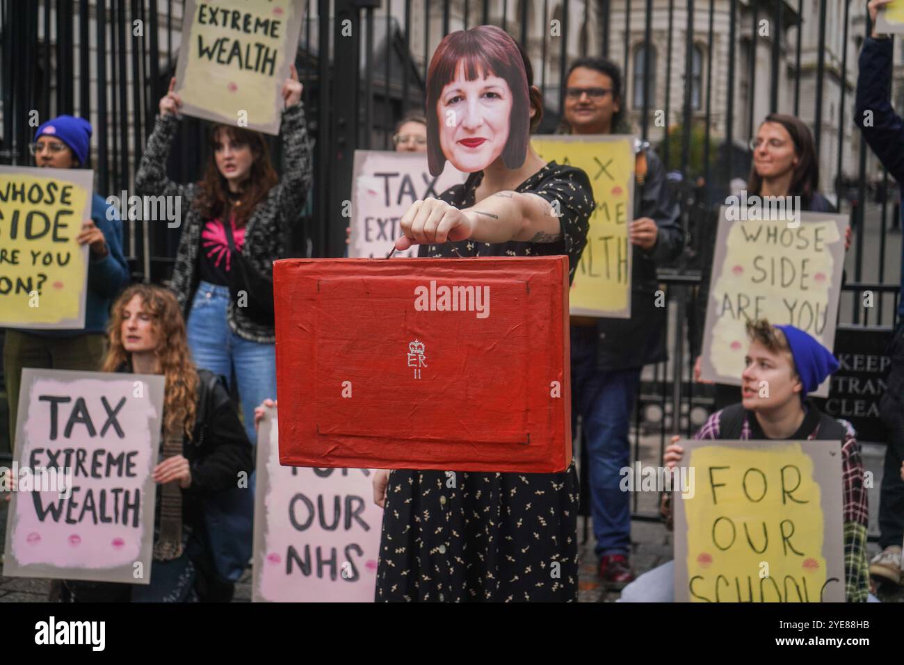 London, UK. 30 October 2024 Protesters hold placards as they ...