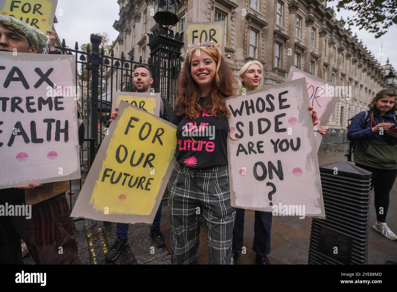 London, UK. 30 October 2024 Protesters hold placards as they ...