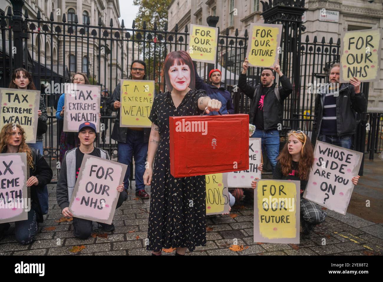 London, UK. 30 October 2024 Protesters hold placards as they ...